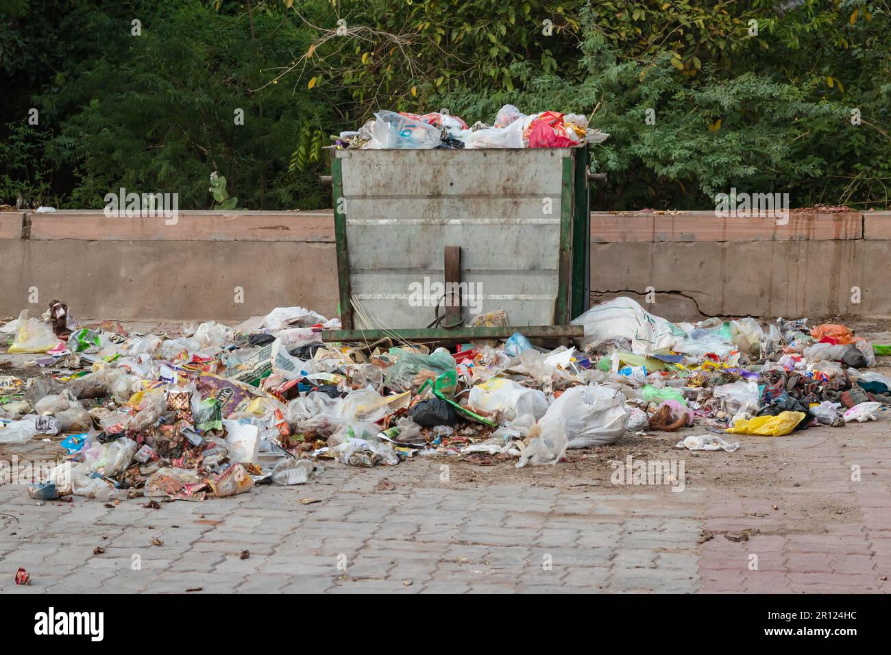 open garbage dust bin liter with plastic begs and waste items at day ...