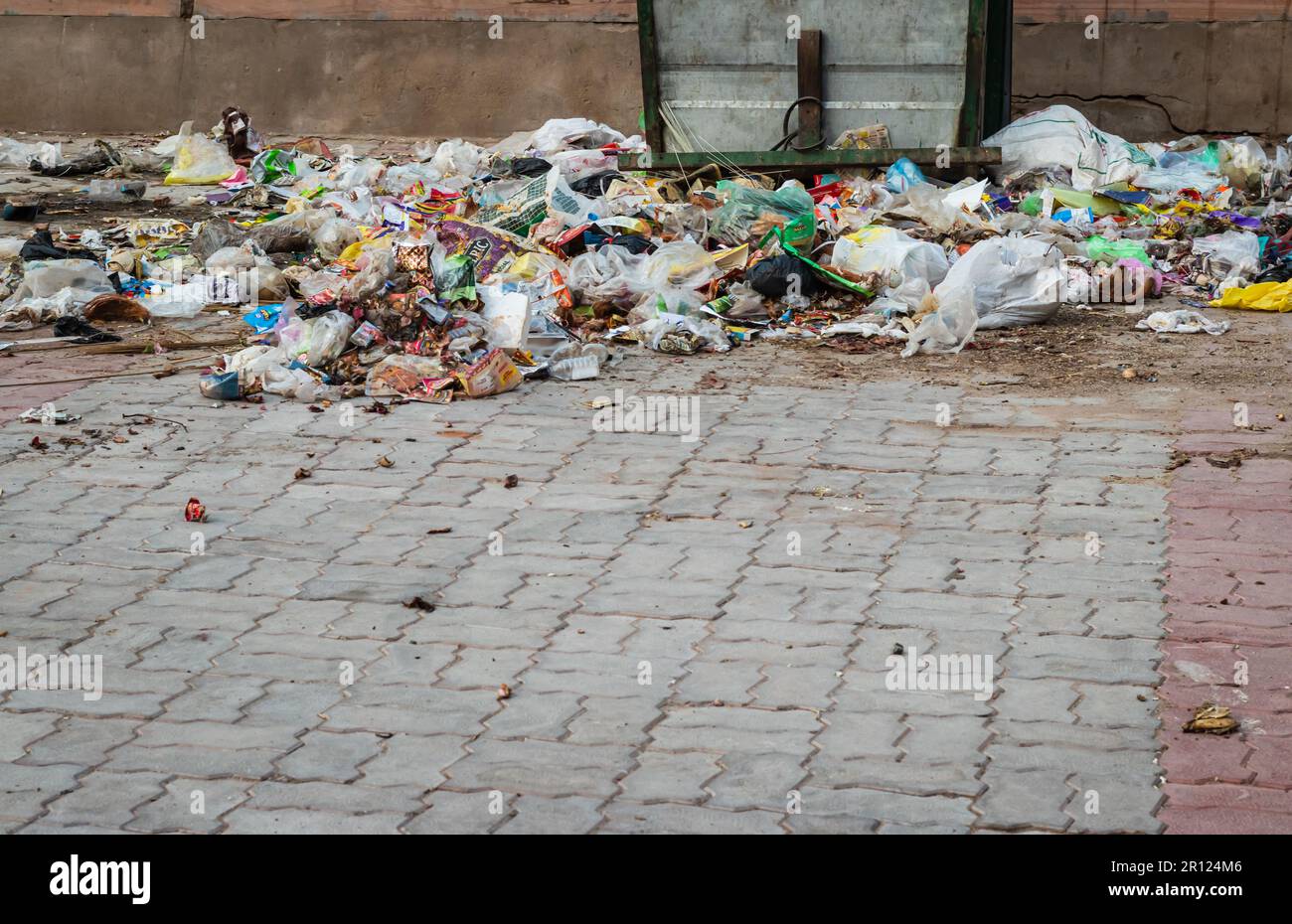 garbage waste items and plastic begs liter in open at day from ...