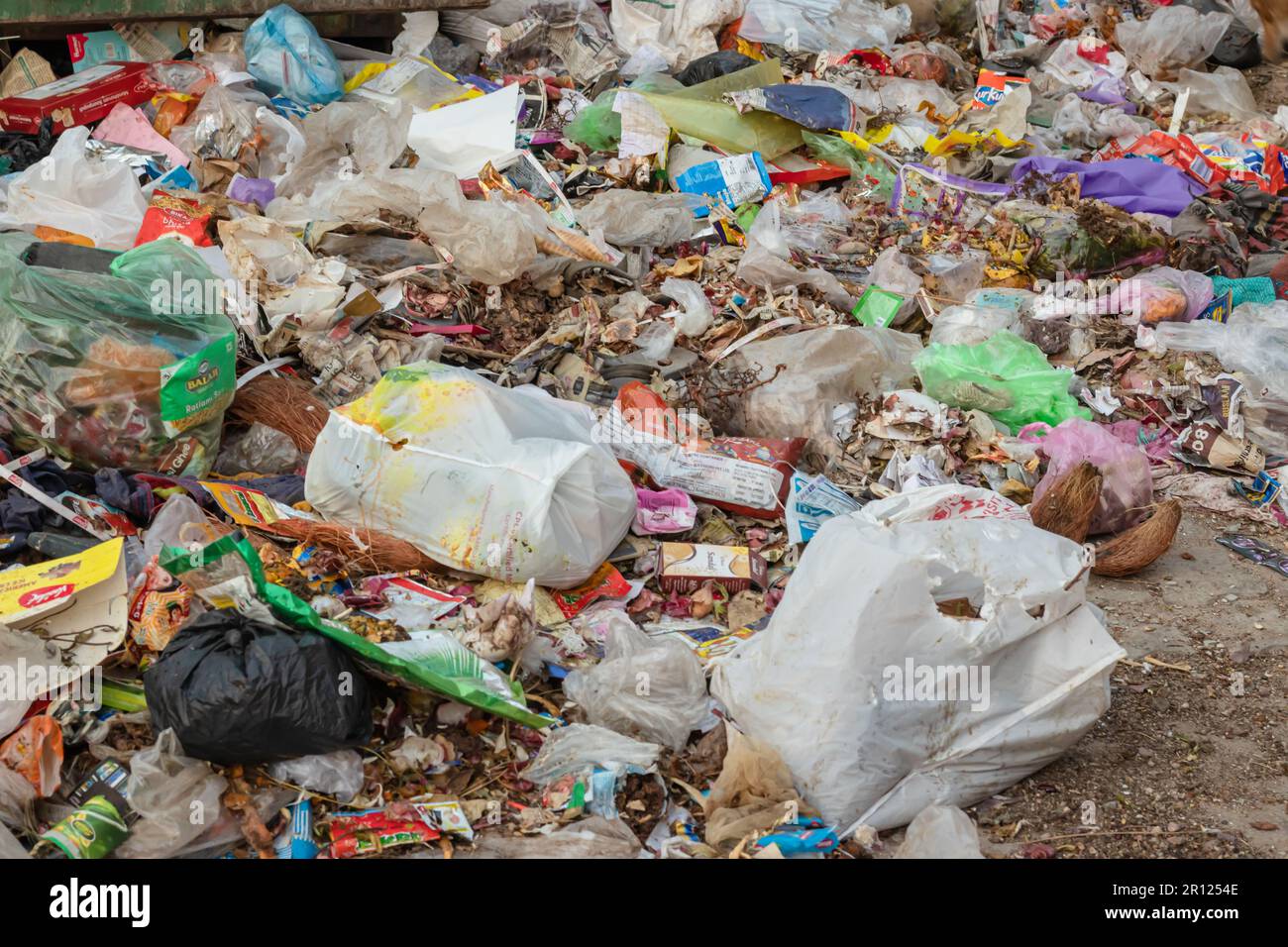 garbage waste items and plastic begs liter in open at day from ...
