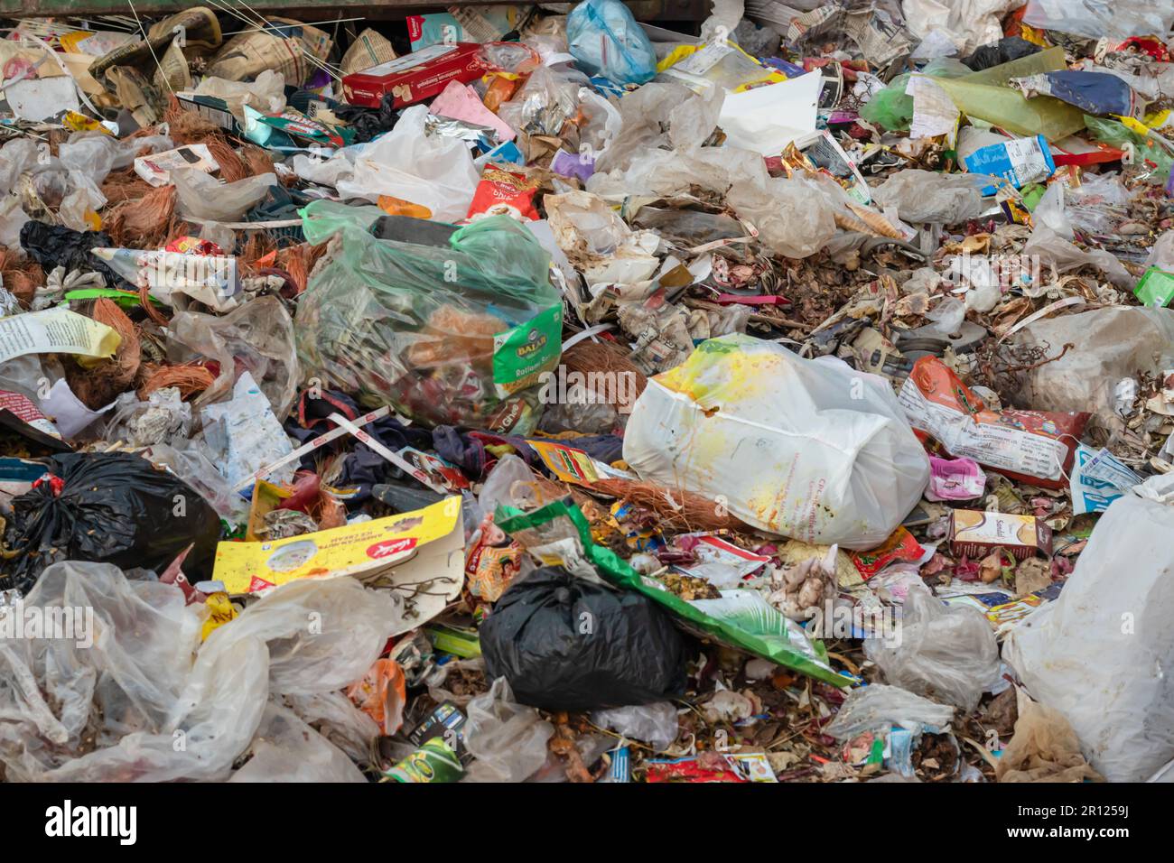 garbage waste items and plastic begs liter in open at day from ...