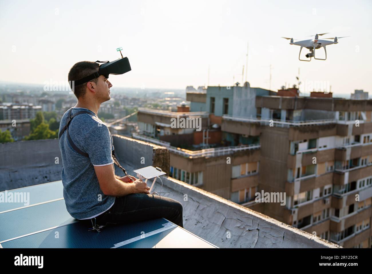 Young technician flying UAV drone with remote control on rooftop Stock ...