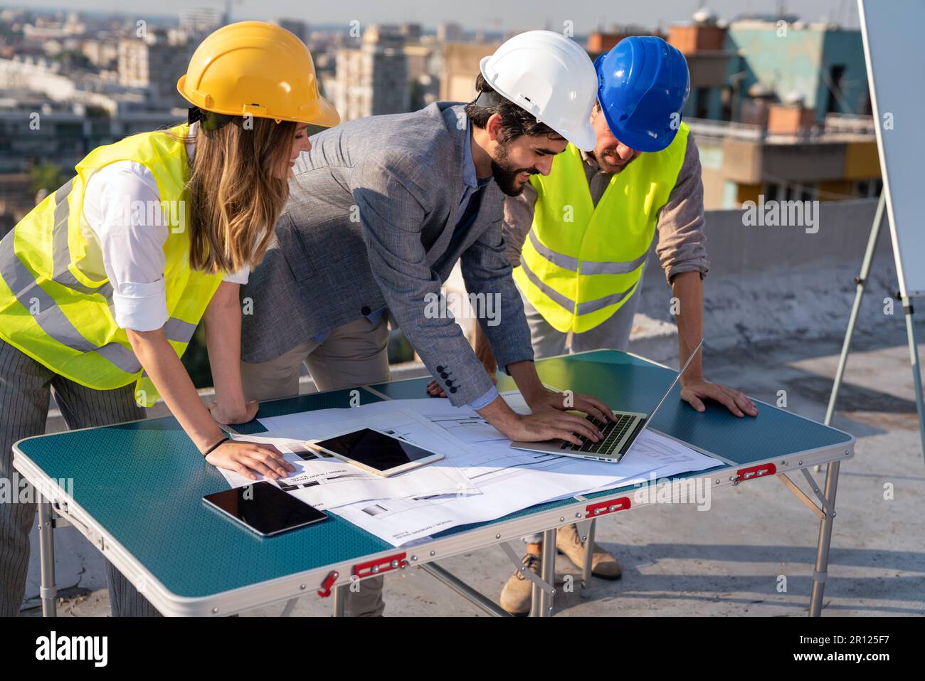 Construction concept. Engineers and architects working at construction ...