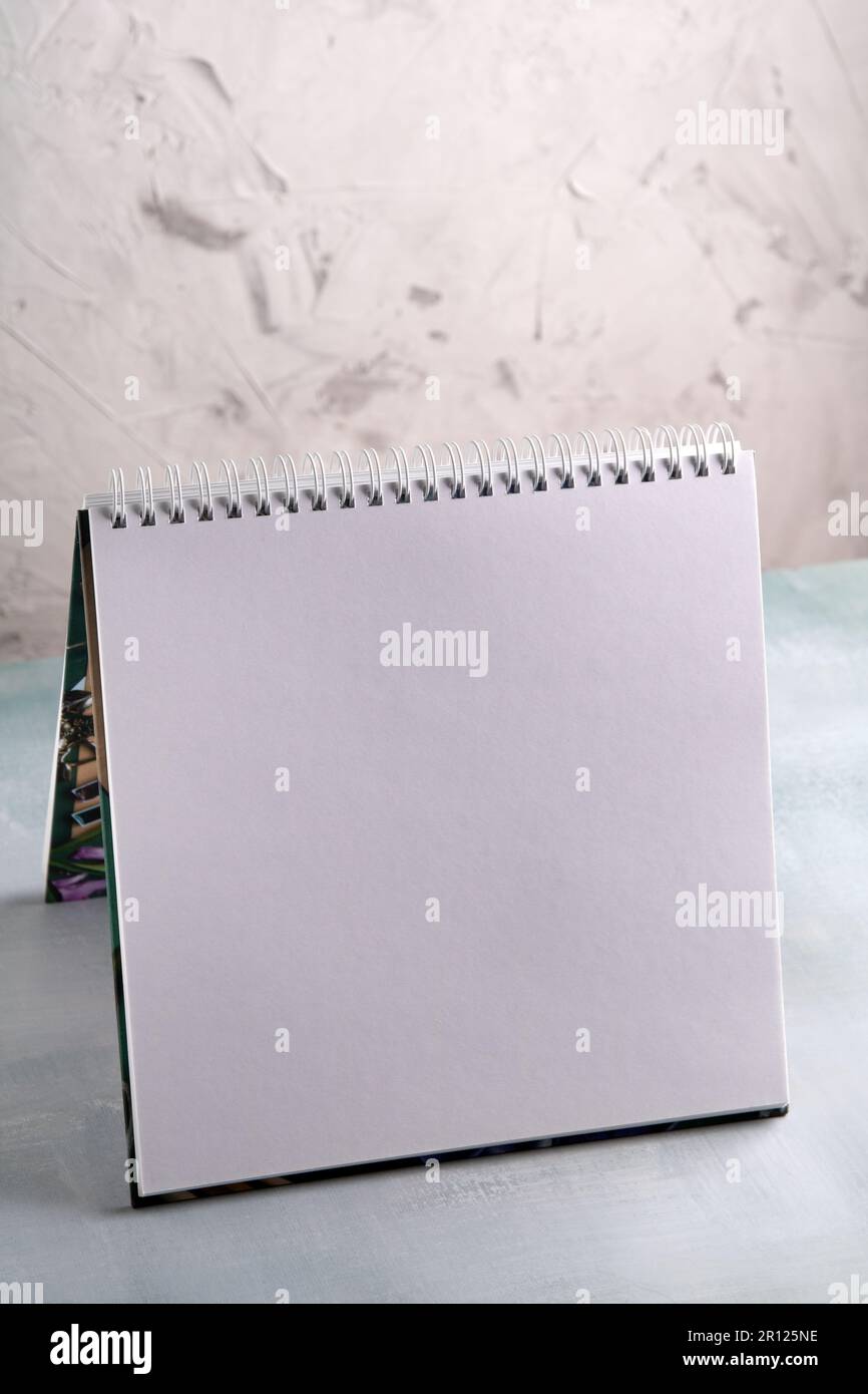 Drawing book photo with a blank sheet of paper on the table, side view ...