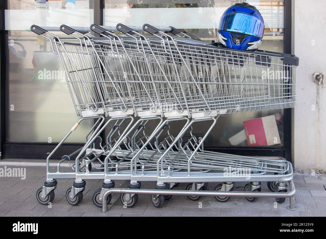 A shopping carts park in front of the supermarket entrance Stock Photo ...