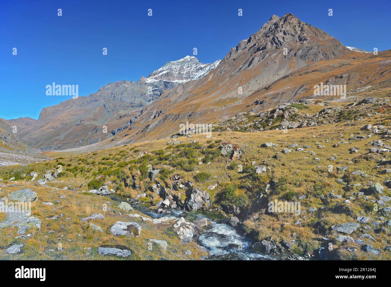 peak mountain in a valley crossing by a little streaming in european ...