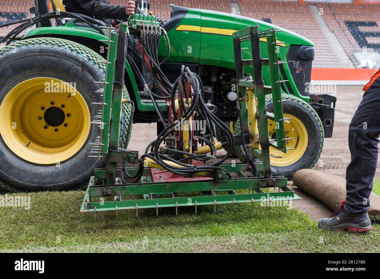 Machine used to shift grass after lauing grass in a roll on a football ...
