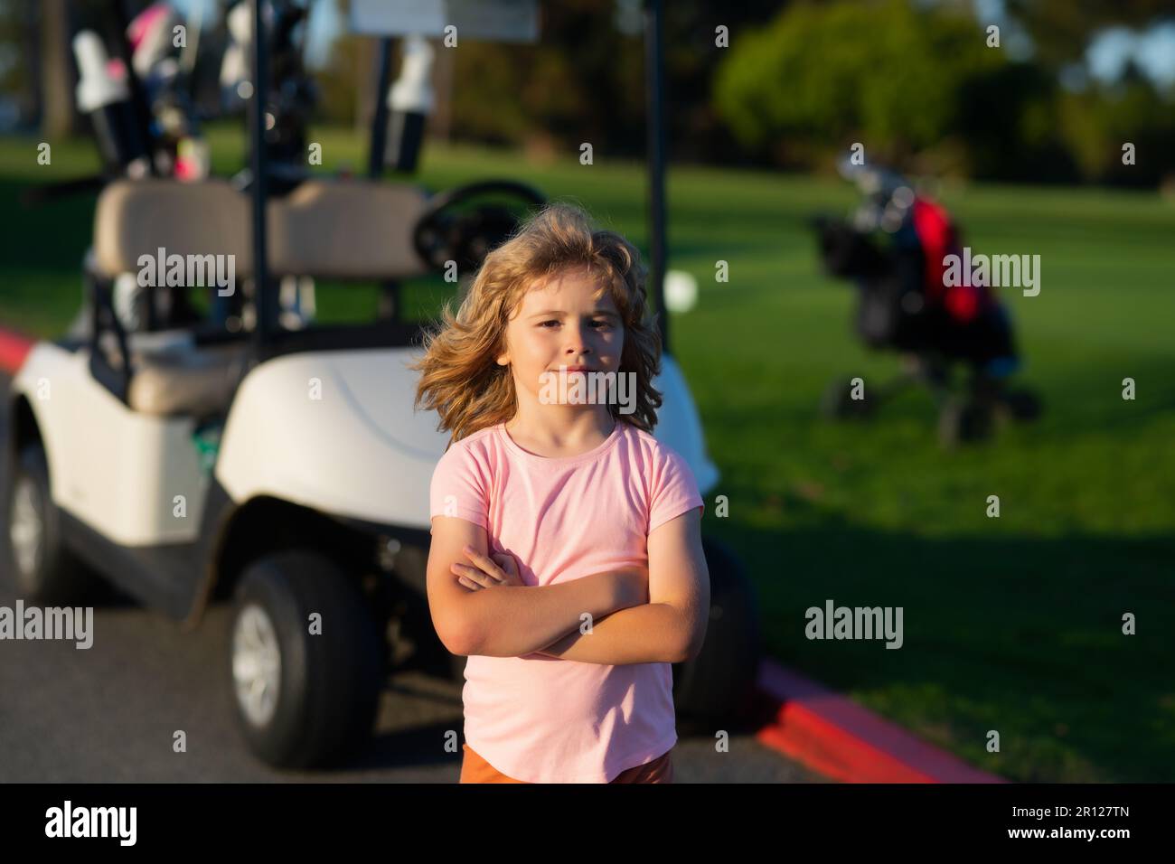 Kid in golf park near golf cart. Child summer vacation. Lifestyle ...