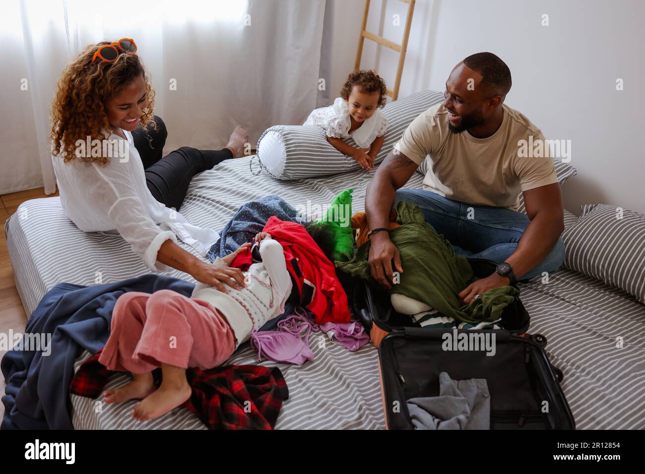 African woman packing suitcase hi-res stock photography and images - Alamy