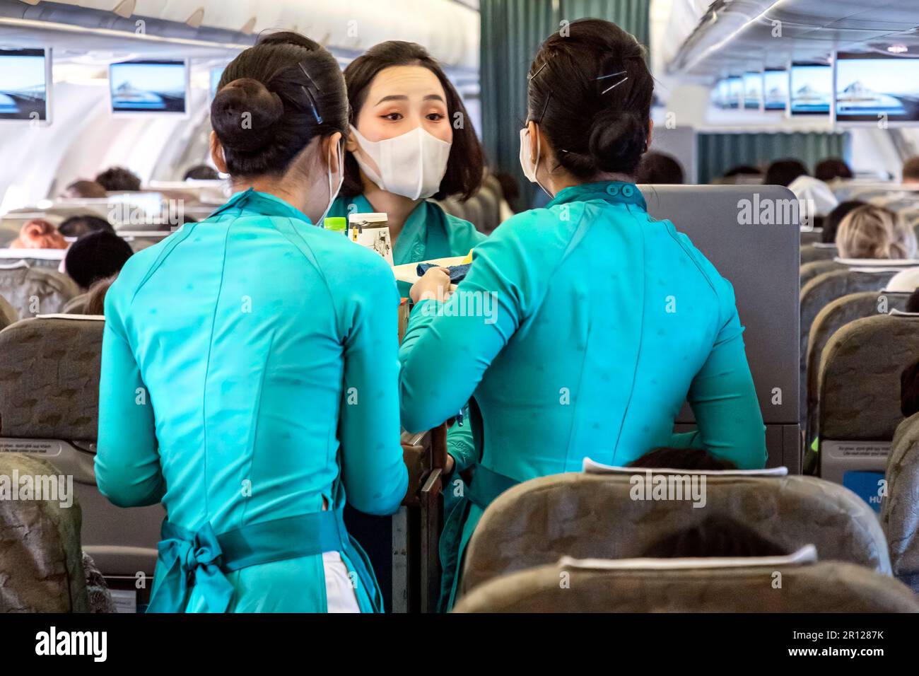Vietnam Airlines cabin crew wearing traditional ao dai uniform on ...