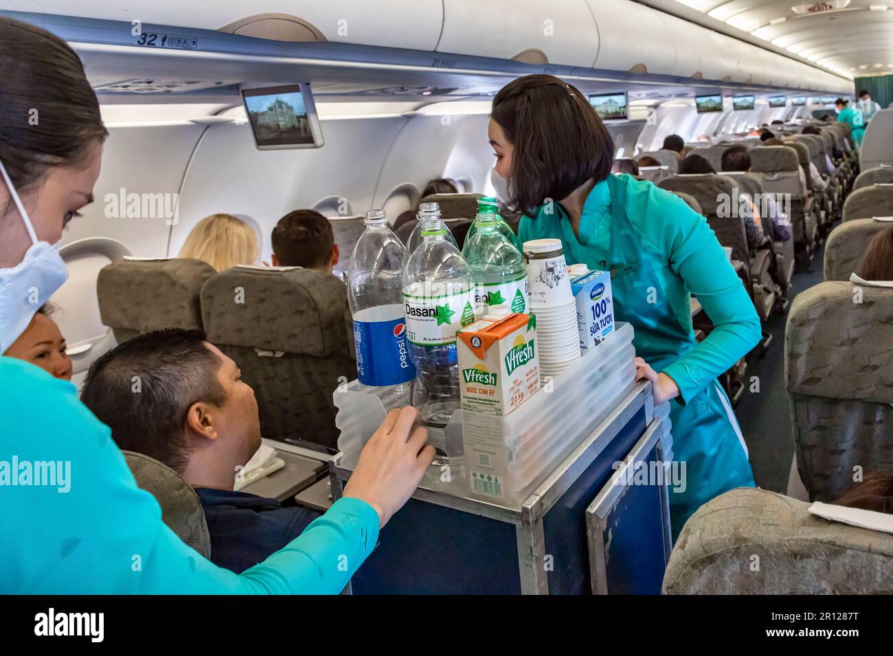 Vietnam Airlines cabin crew wearing traditional ao dai uniform on ...