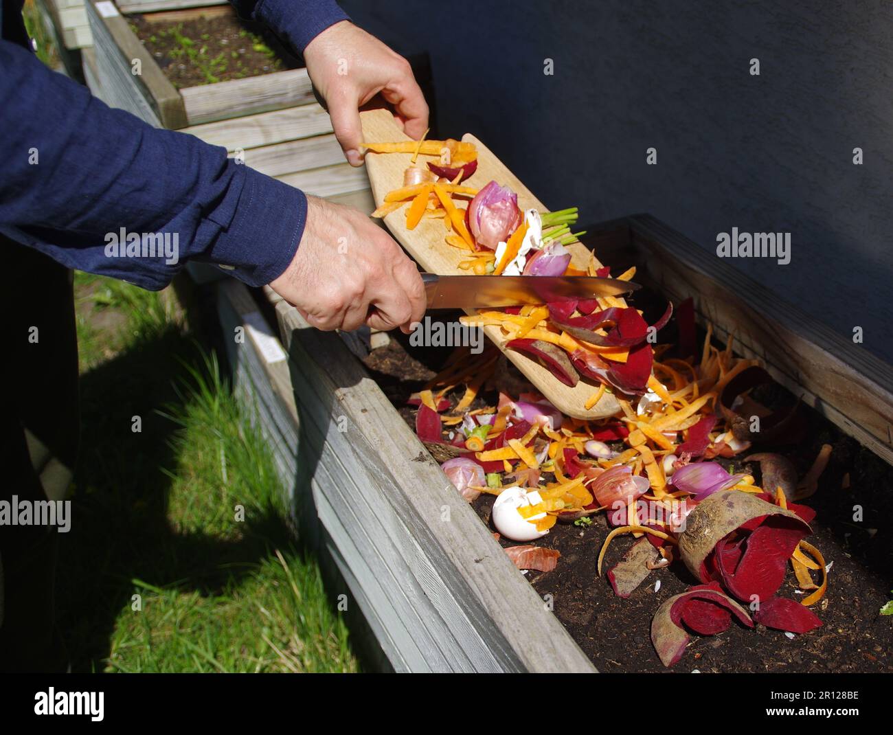 Compost from organic waste. Man throws kitchen vegetable fruit and egg ...