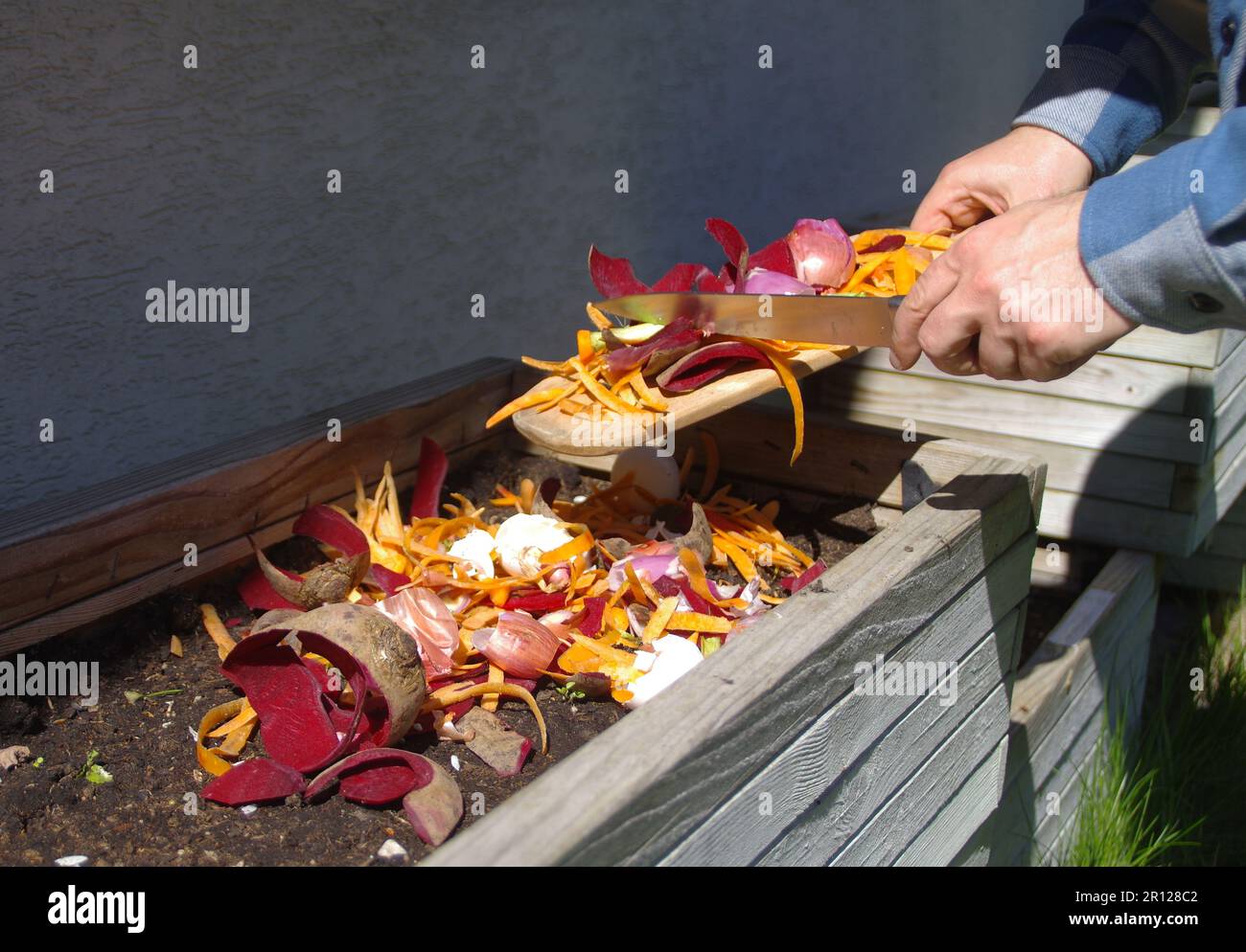 Compost from organic waste. Man throws kitchen vegetable fruit and egg ...