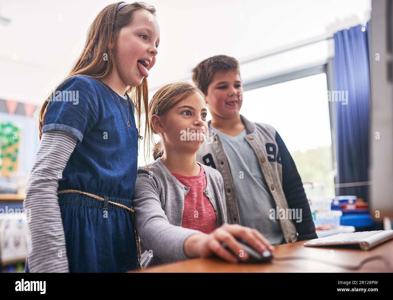 Lets make funny faces and take pictures. elementary school children in ...