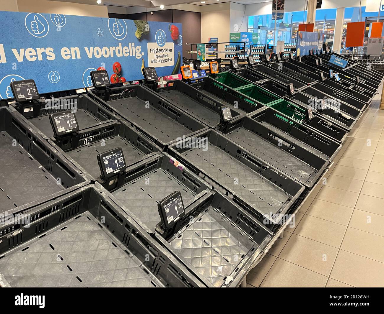 Price tags without product at the fruit corner with empty crates in ...