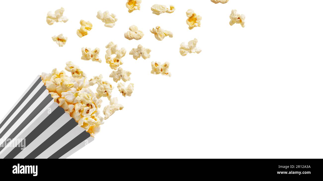 Popcorn flying out of black white striped paper box isolated on white ...