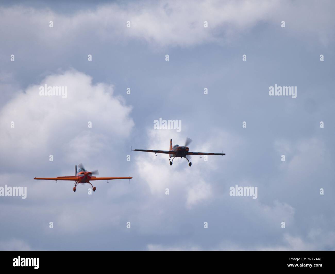 Two aerobatic airplanes takes off at an air show, soaring through the ...