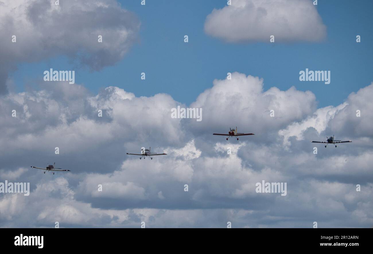 Four airplanes flying together in an air show Stock Photo - Alamy