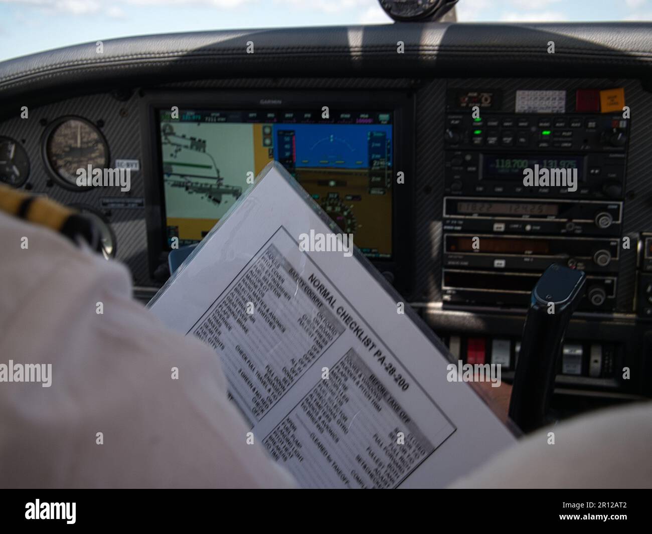 A pilot holds the checklist in the cockpit of a small plane Stock Photo ...