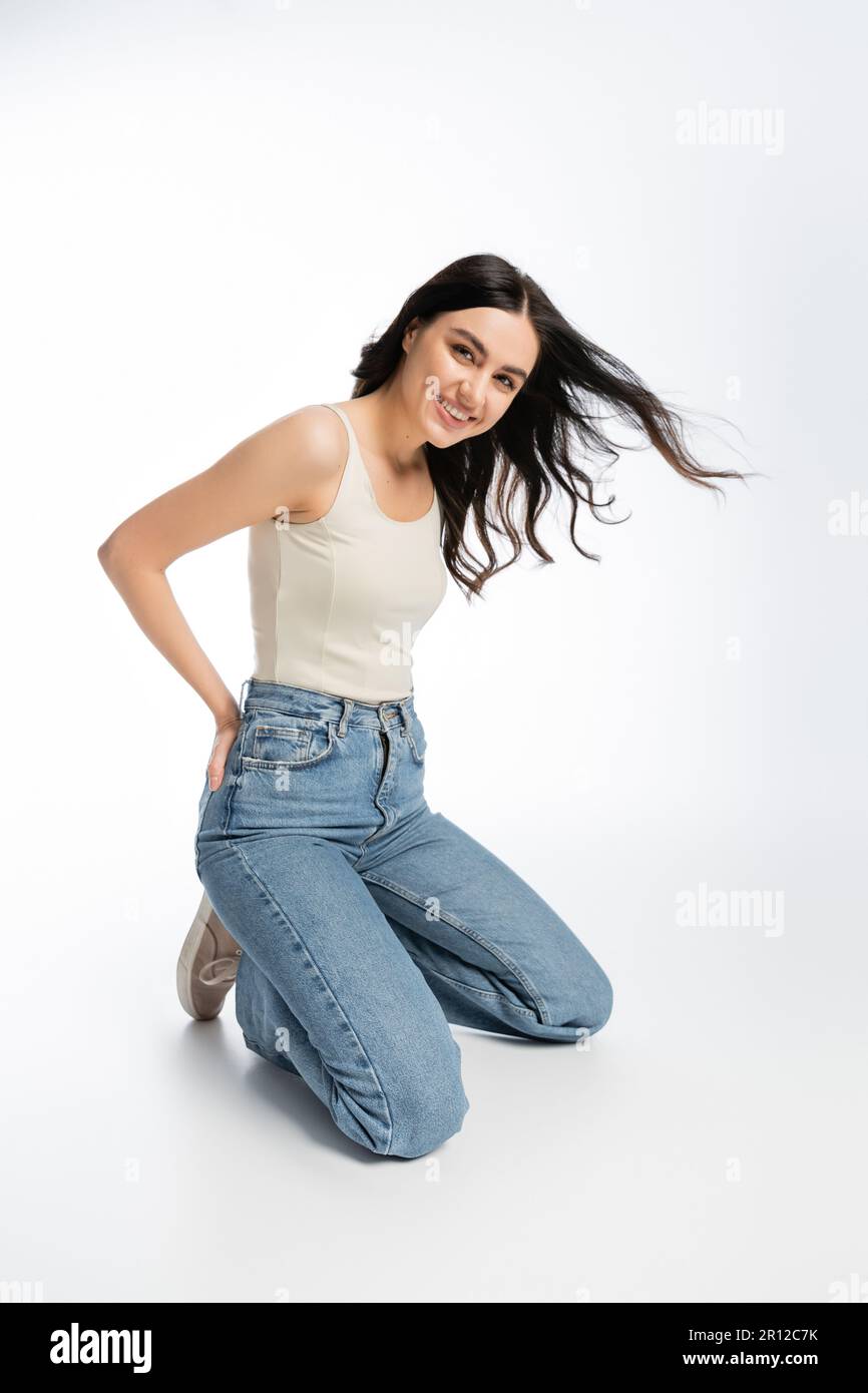 full length of young and gorgeous woman with flawless makeup, brunette hair and perfect skin ...