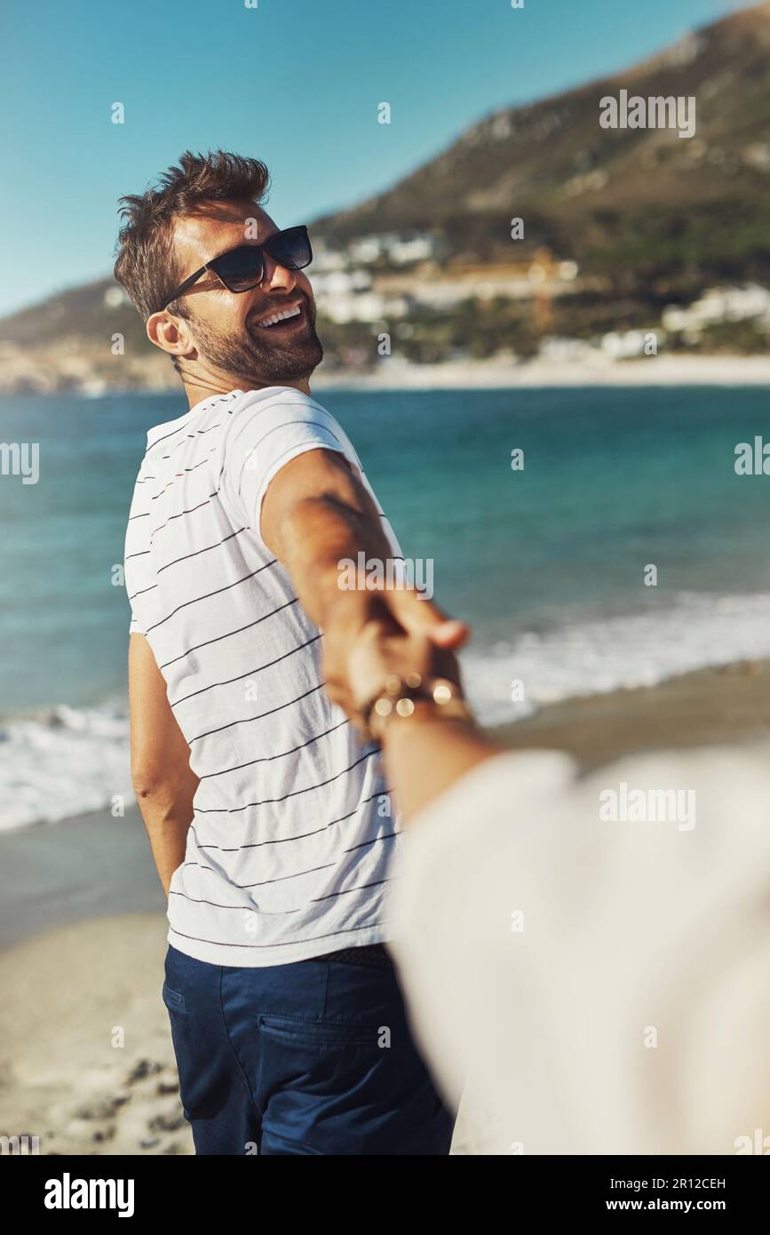Lets go to where the sun shines all the time. a young man holding his ...