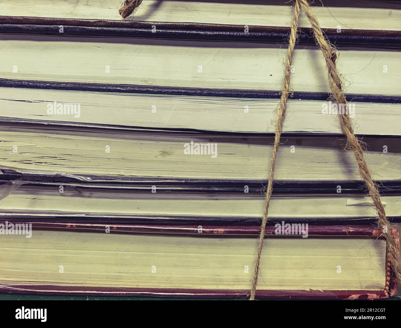 Pile of old books with rope background Stock Photo - Alamy