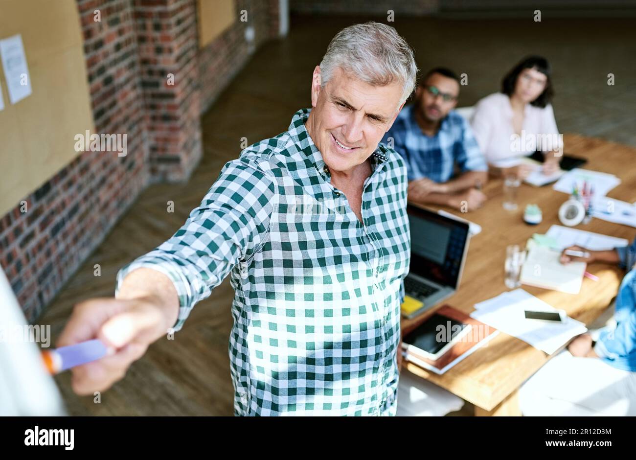 Keeping the big vision in sight. a businessman giving a presentation in ...