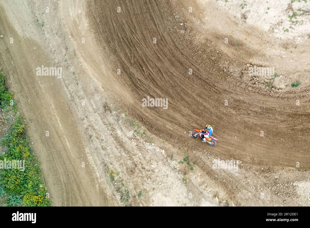 Drone aerial of a motocross race on a dirt curvy sport track. Aerial ...
