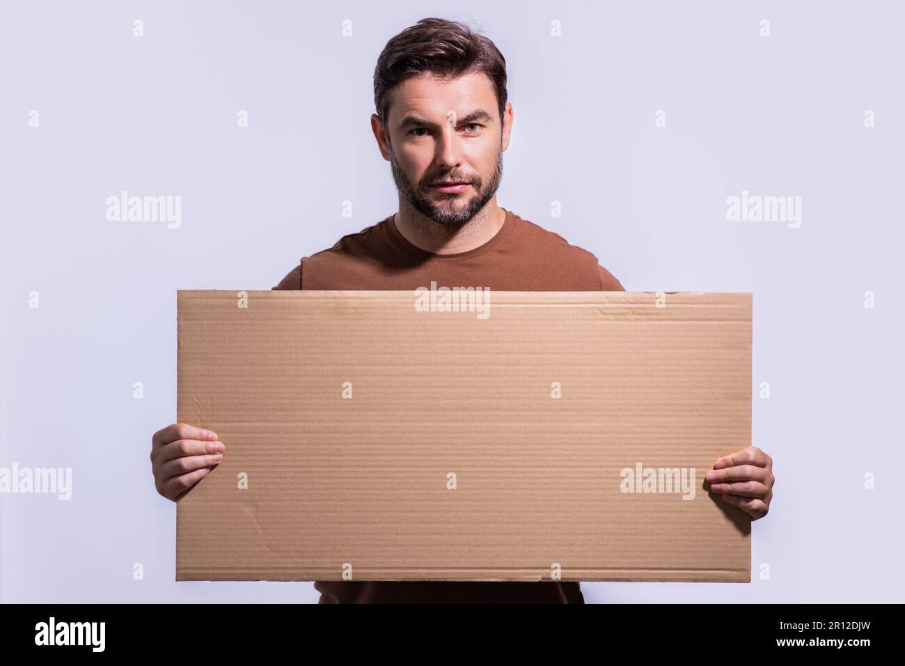 Man with empty blank board on studio background. Blank signboard with ...