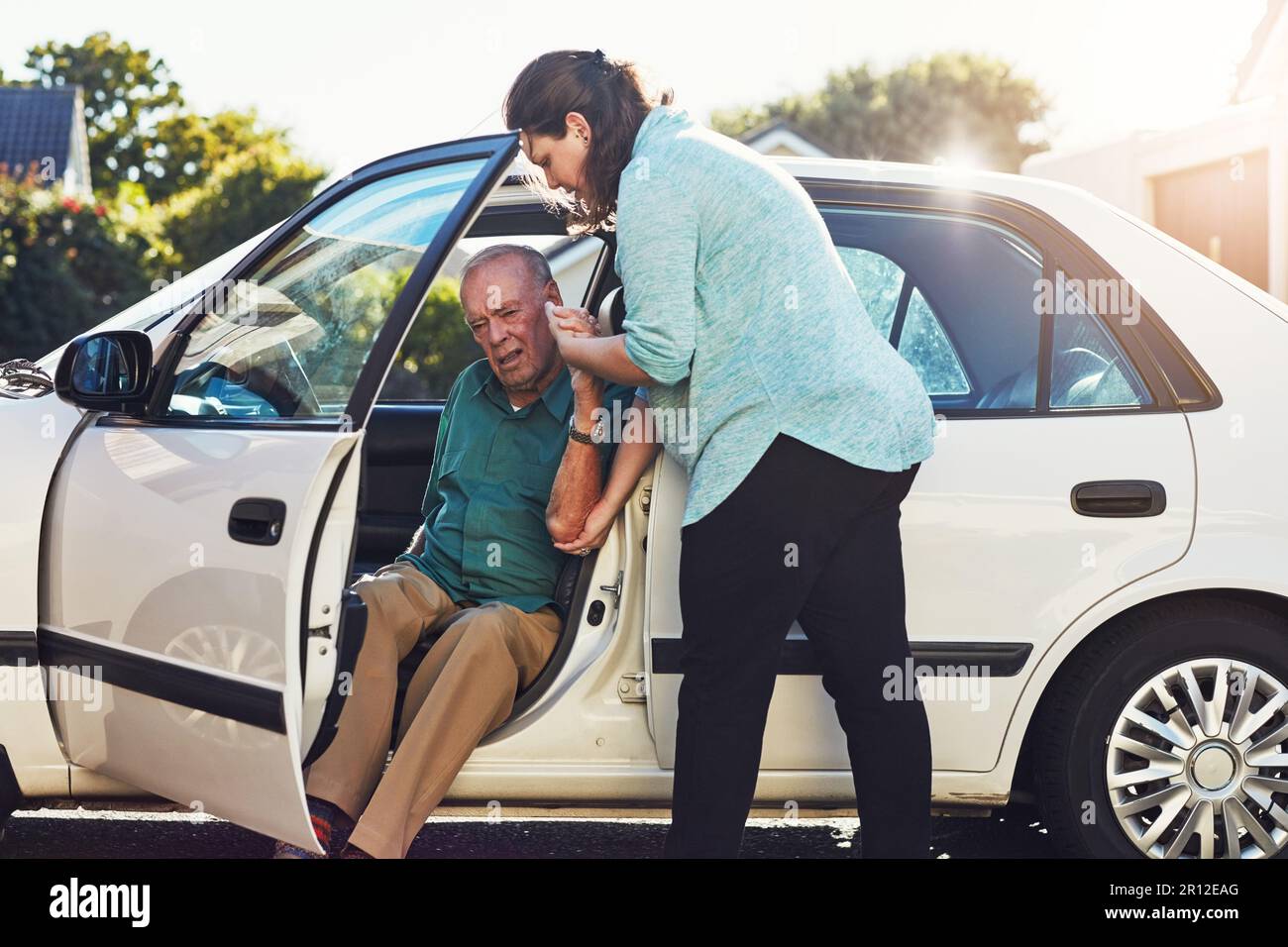 Lets get you out of there. a woman helping her senior father out of the ...