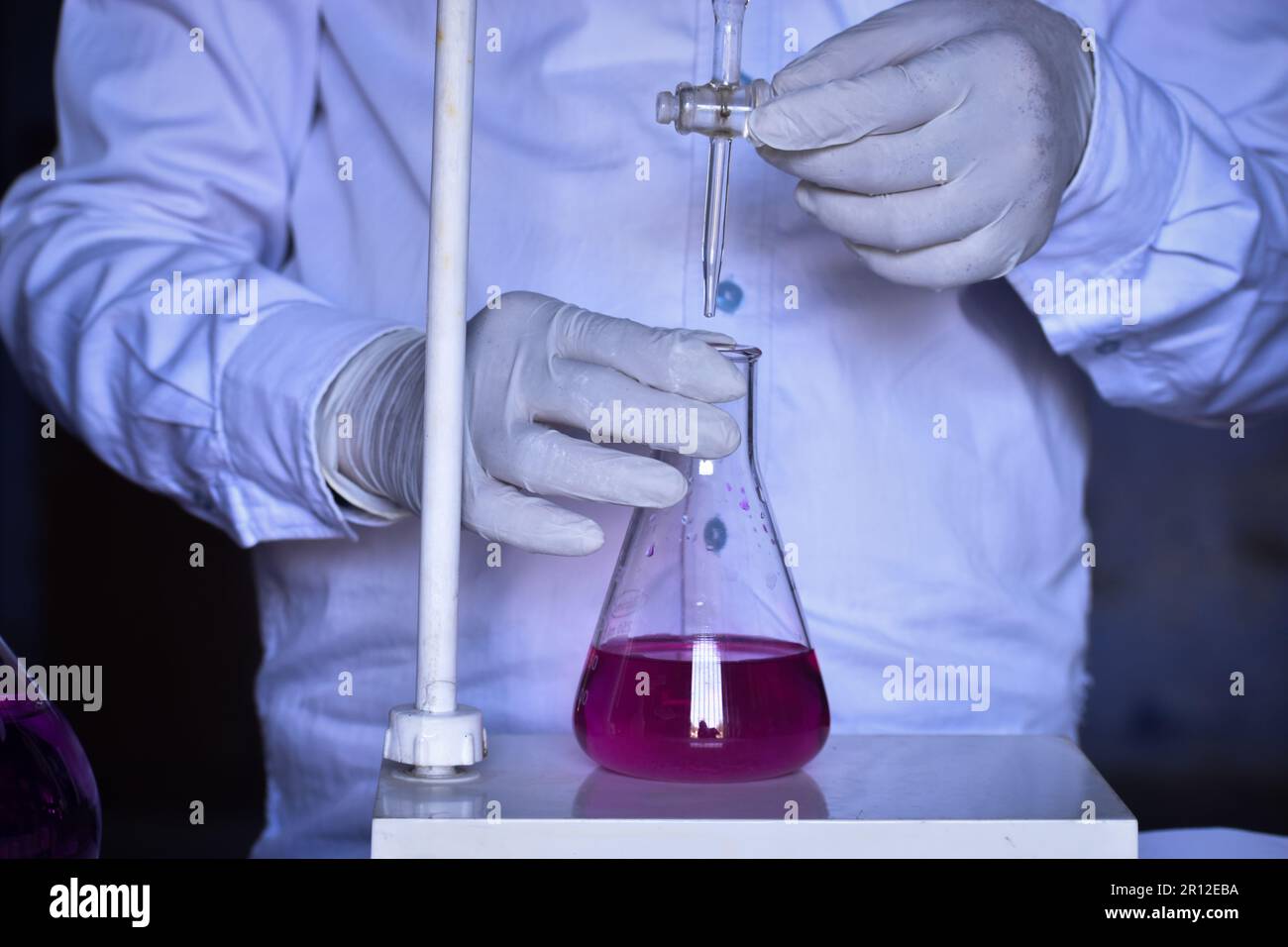 The scientist is conducting an acid-base titration in the lab ...