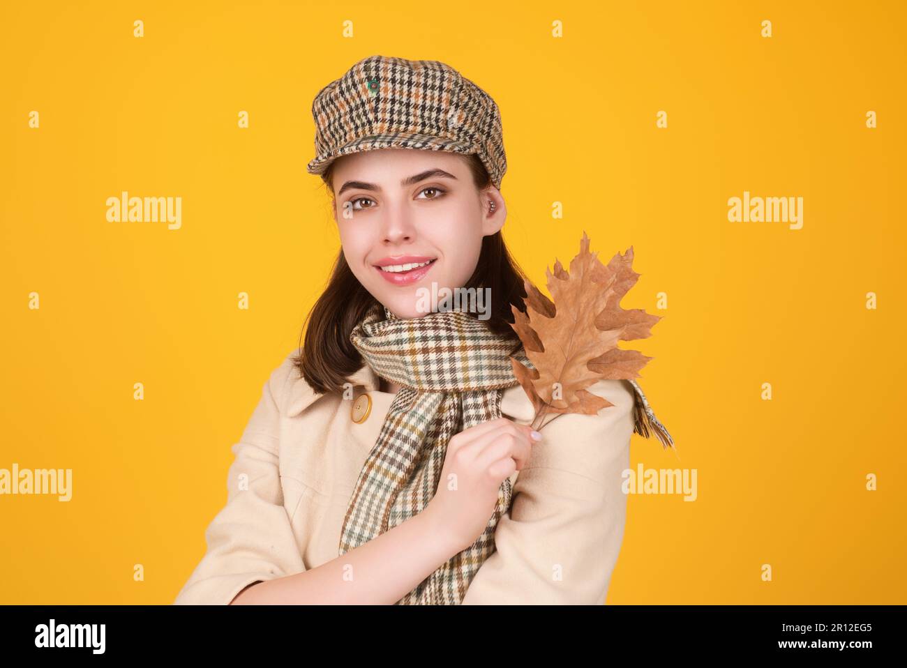 Autumn portrait happy smiling woman holding fall maple leaves near face ...