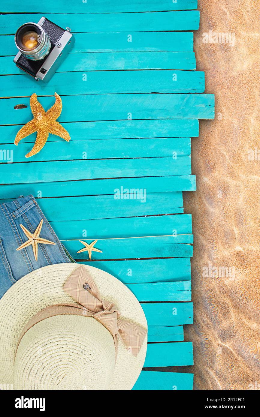 Blue pier boards or sun lounger with shorts, straw hat, starfish and ...
