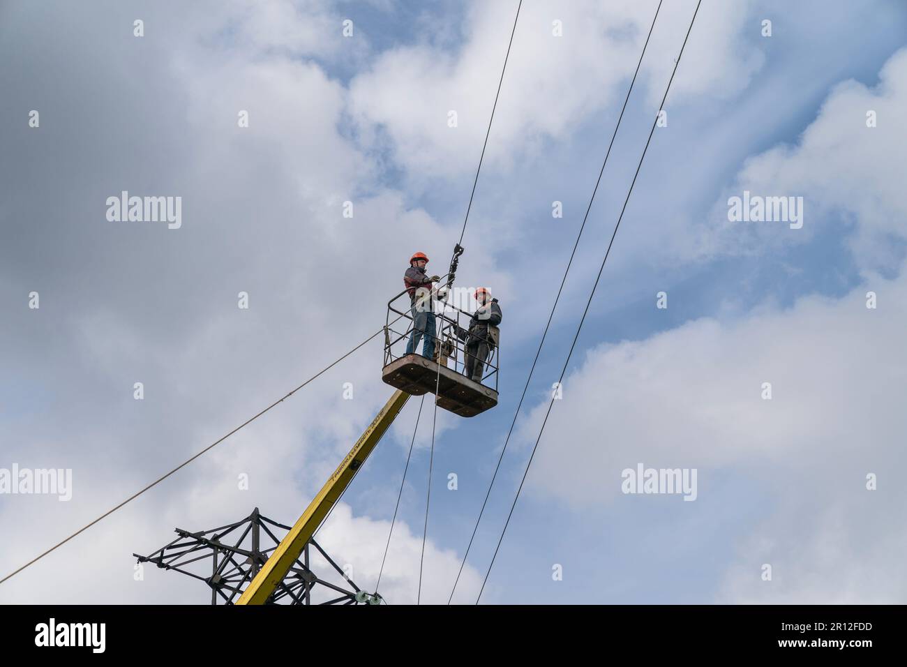 Workers fixing electric power transmission line destroyed during ...