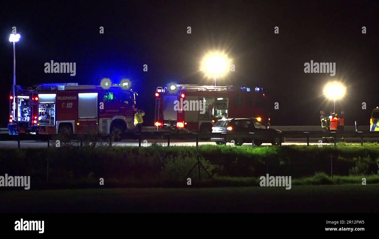 11 May 2023, Brandenburg, Brück: Fire engines illuminate the scene and ...