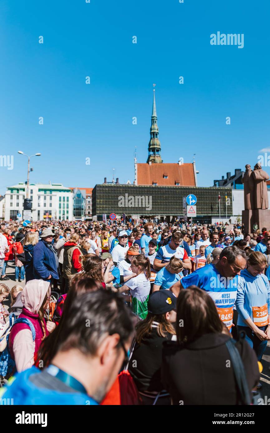 A diverse crowd of people gathered together in the city for a festive ...