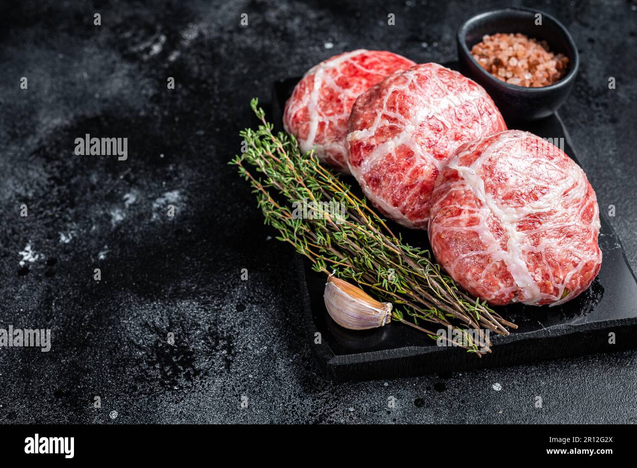 Raw Atriaux cutlets, ground pork wrapped in caul fat, swiss sausage ...