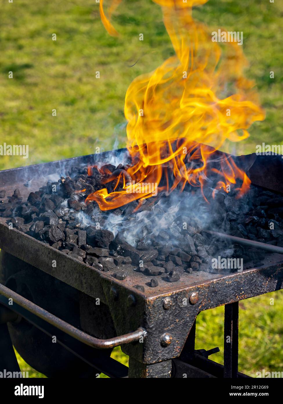 Mobile forge with fire and iron bar Stock Photo - Alamy