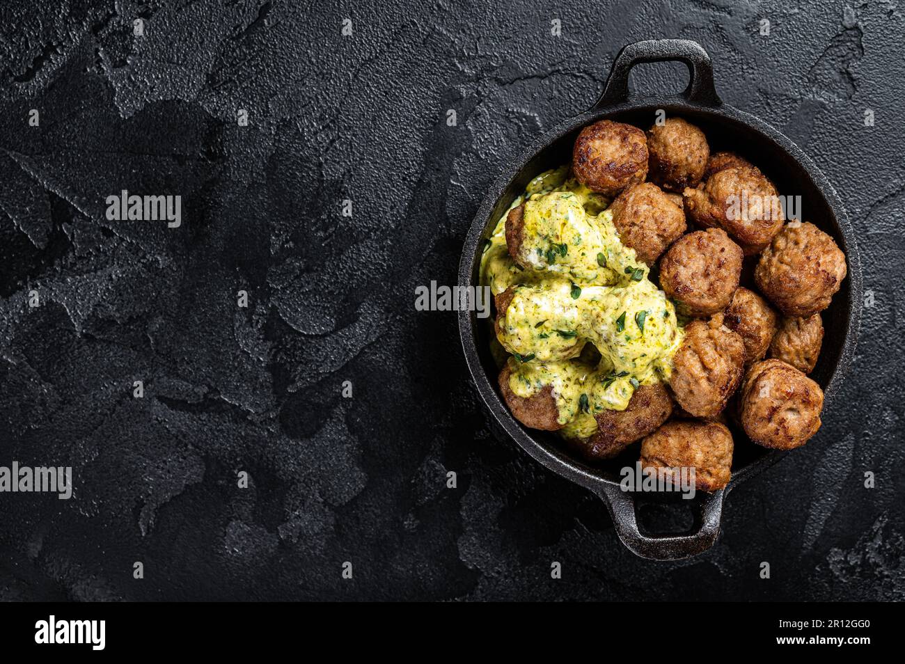 Skillet with Swedish beef Meatballs with Cream Sauce. Black background ...