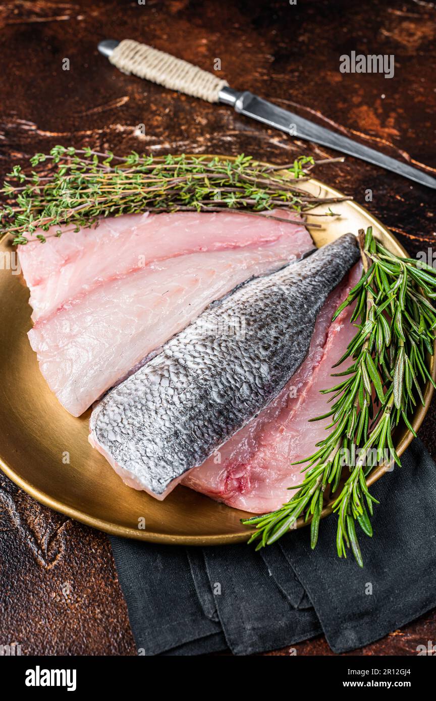 Fresh Raw Gilthead Sea bream fish fillets ready for cooking. Dark ...