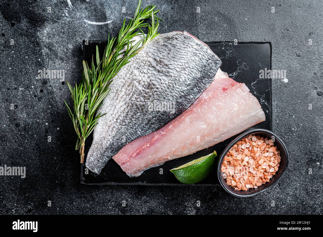 Uncooked Raw Dorado Sea bream fish fillets. Black background. Top view ...