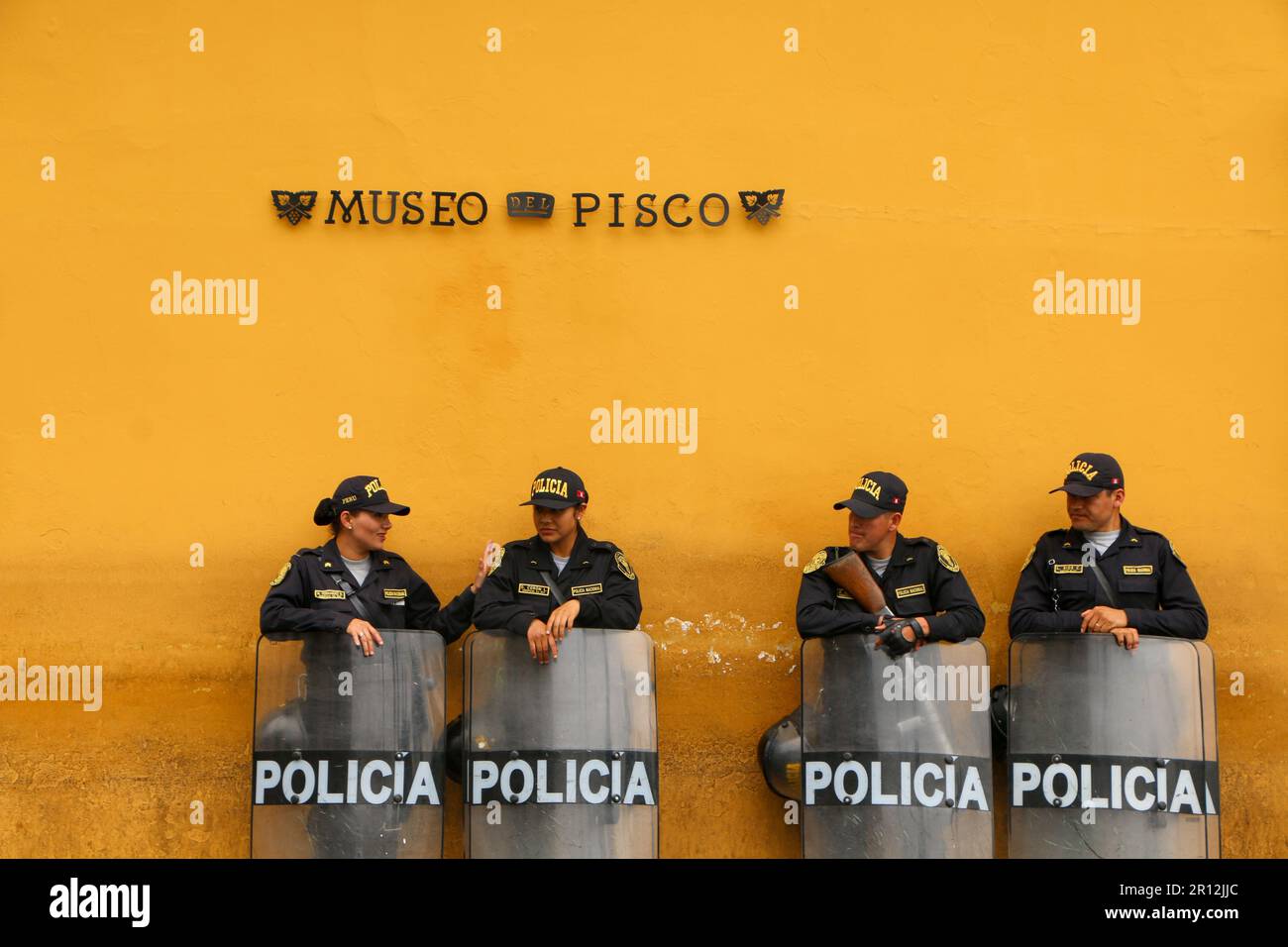 A group of law enforcement officers standing in formation in front of a ...