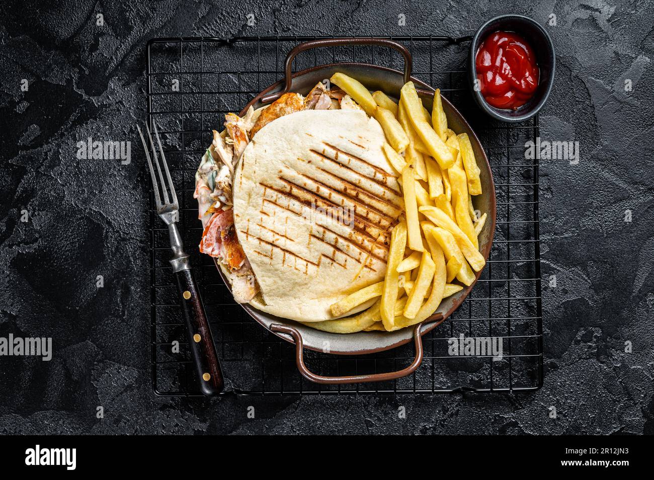 Doner kebab sandwich in grilled pita bread with vegetables and chicken ...