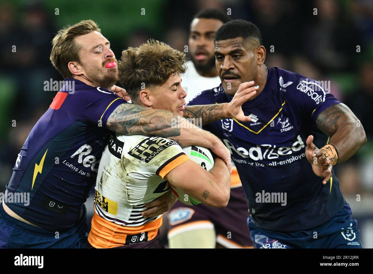 Cameron Munster of the Storm tackles Reece Walsh of the Broncos during ...