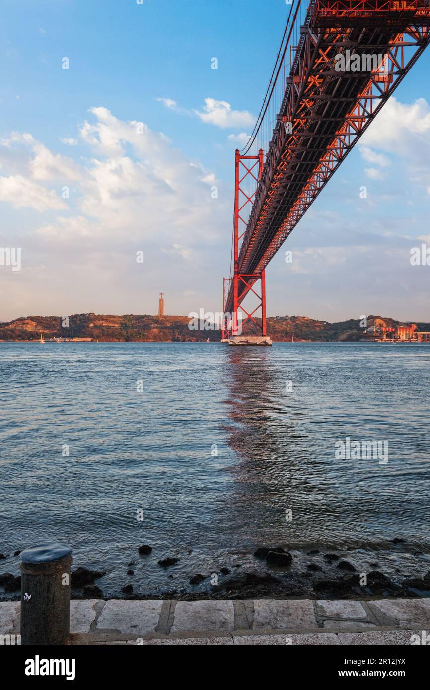 View of 25 de Abril Bridge over Tagus river, Christ the King monument ...