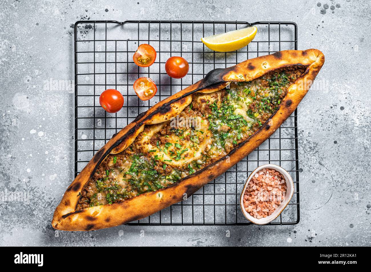 Turkish pide, traditional pie with beef meat and vegetables. White ...
