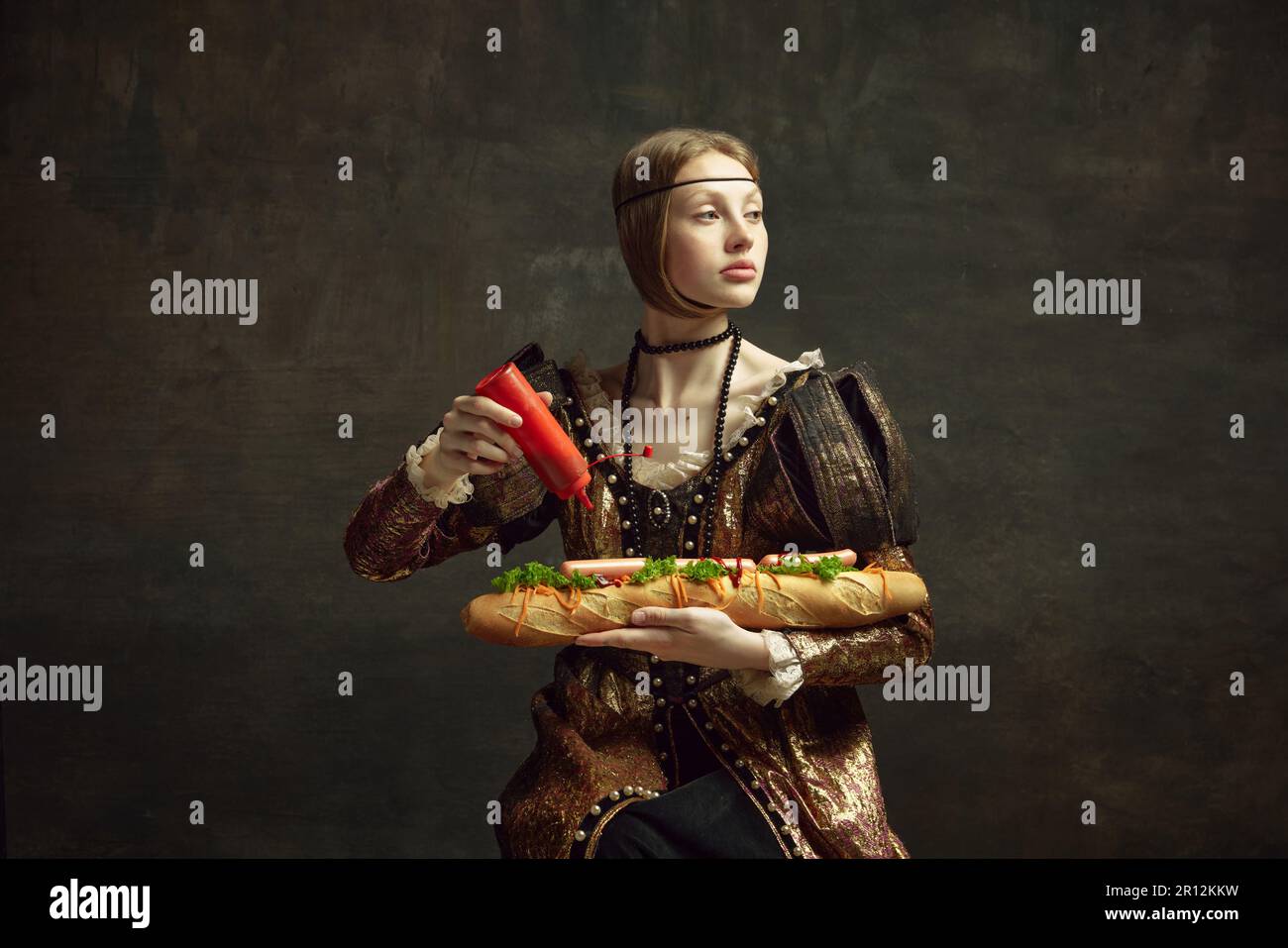 Portrait of young girl, queen, princess in vintage costume putting ...