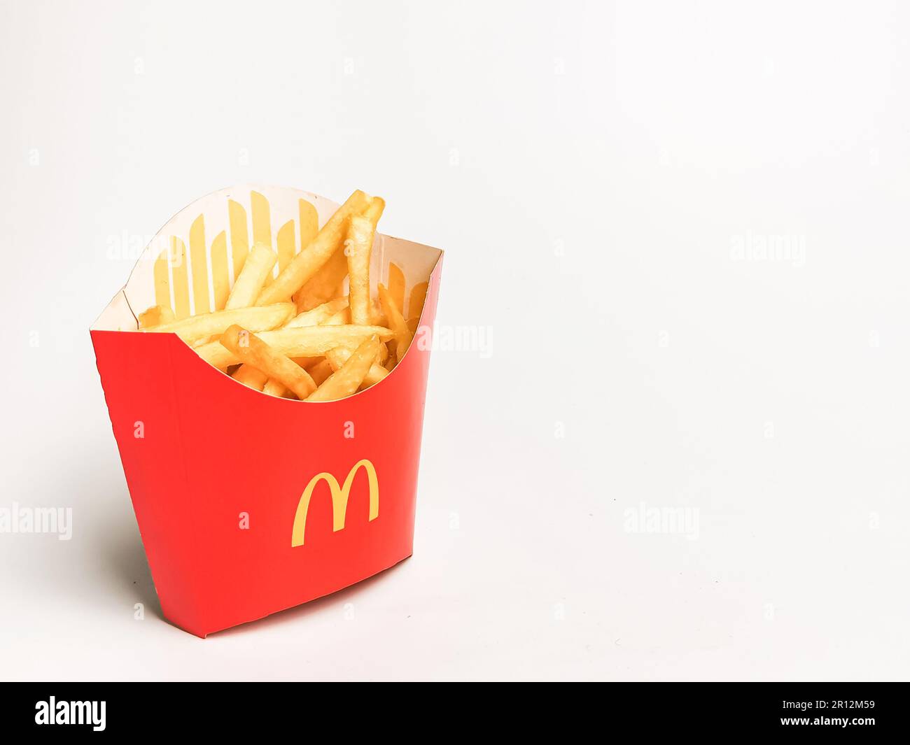A box of McDonald's french fries on a white background, ready to be ...