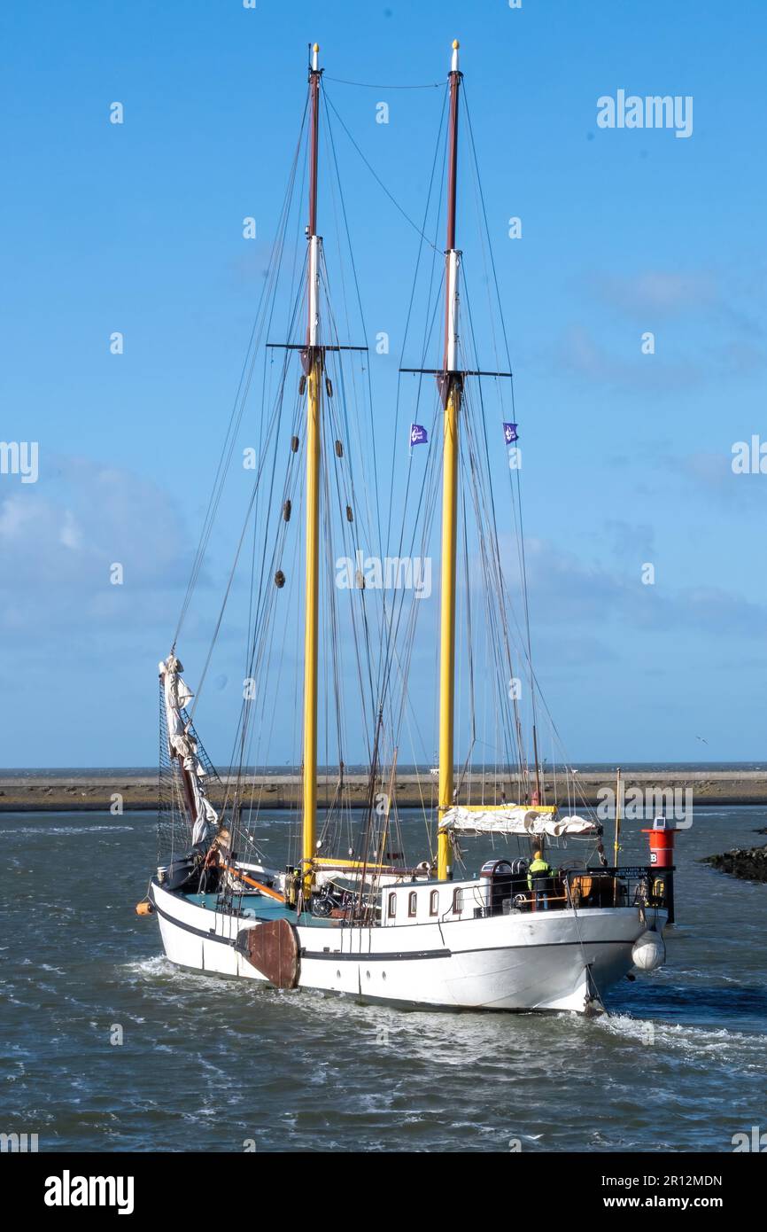 A majestic white sailing boat with multiple masts drifting peacefully ...