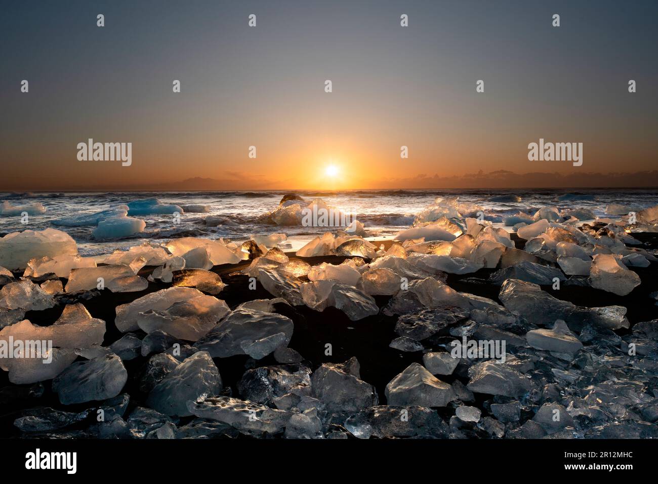 A beautiful seascape featuring a sunlit shoreline with a vast spread of ...