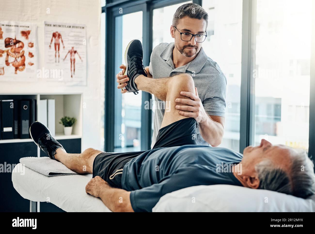 Stretching legs, rehabilitation and a physiotherapist with a man for ...